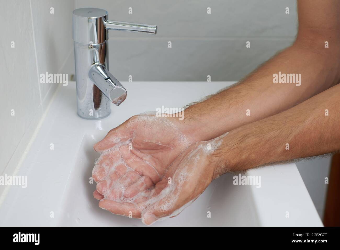 Hand washing with soap in a bathroom Stock Photo - Alamy