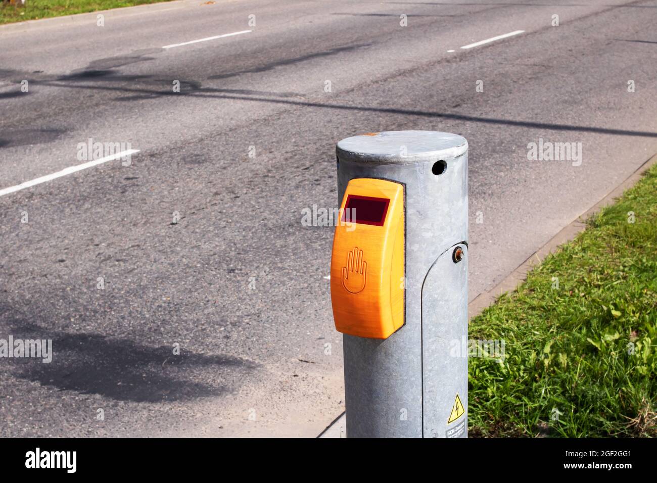 Yellow traffic light button on road background close up Stock Photo - Alamy