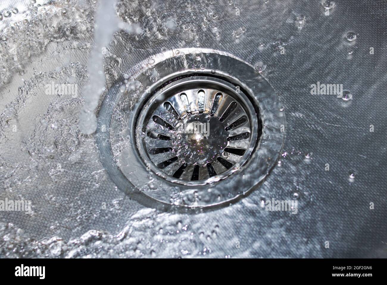 Metal kitchen sink and faucet close up, top view Stock Photo - Alamy