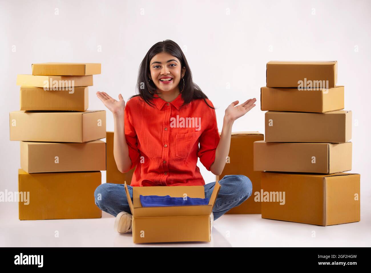 Young woman sitting by cardboard box hi-res stock photography and ...