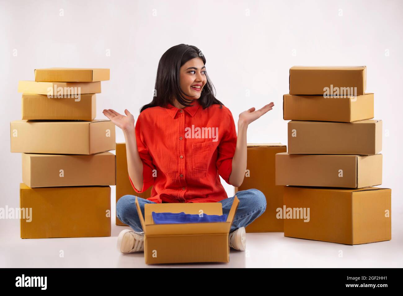 Young woman sitting by cardboard box hi-res stock photography and ...