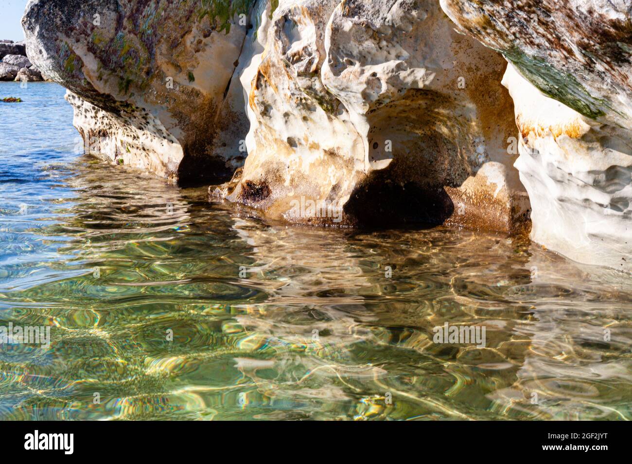 Bright summer morning in Numana, Italy with big rocks surrounding the ...