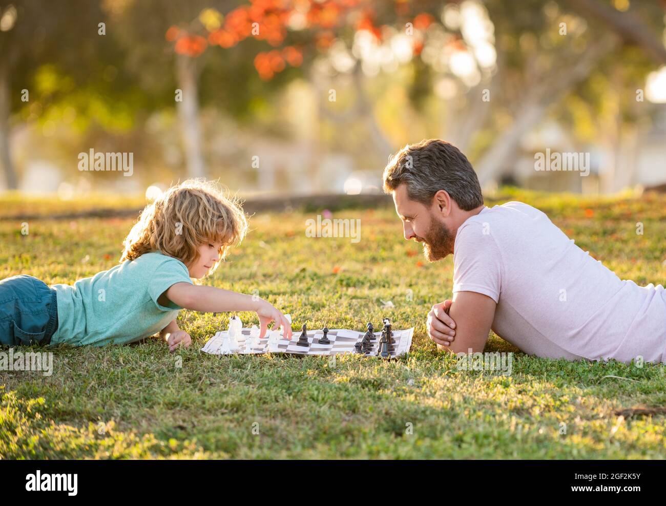 strategic and tactic. tutorship. dad and kid play logic game. father ...
