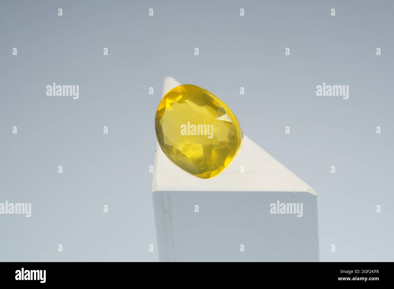 Natural stone yellow opal on a white background Stock Photo - Alamy