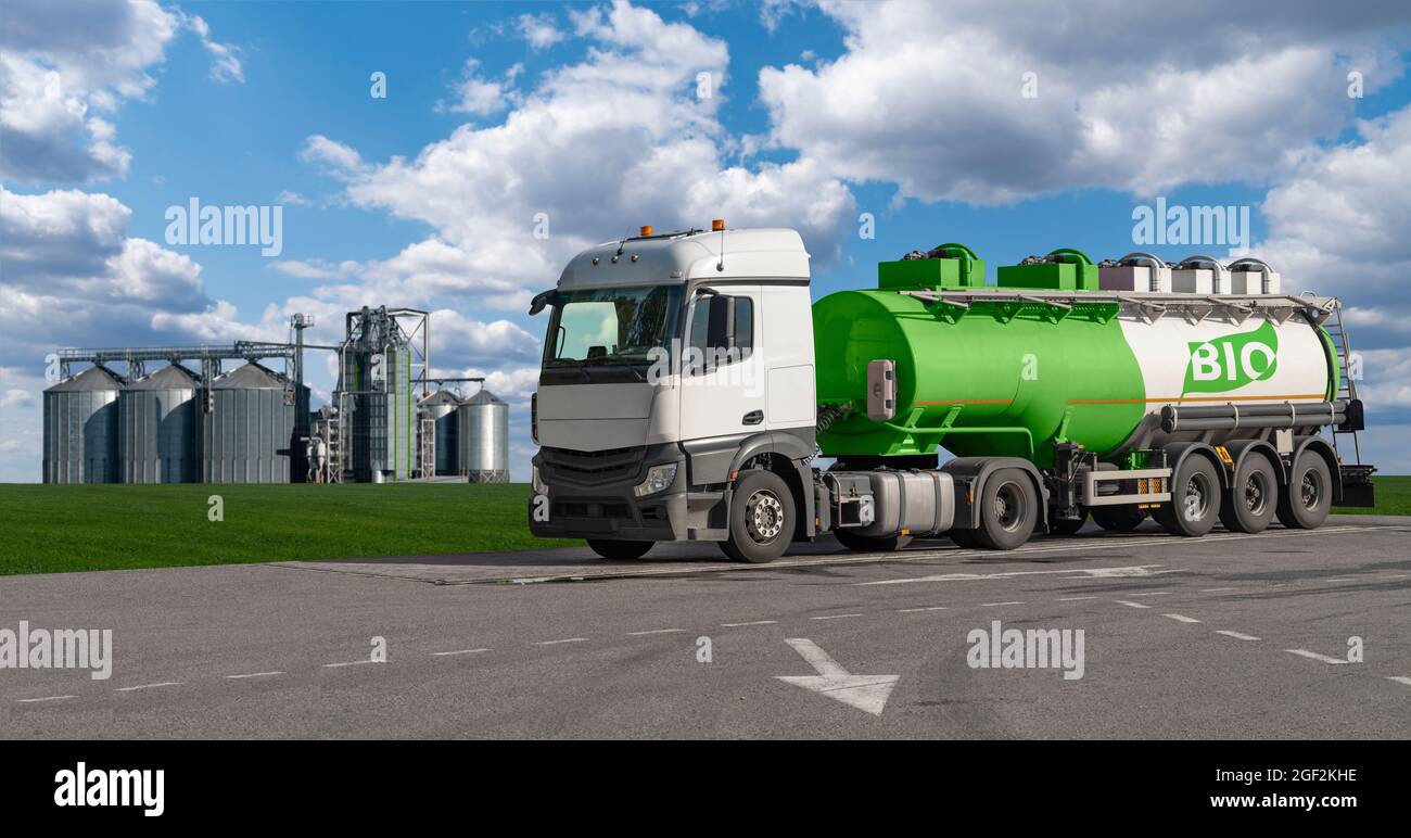 Truck with a tank with the inscription BIO on the background of silos ...