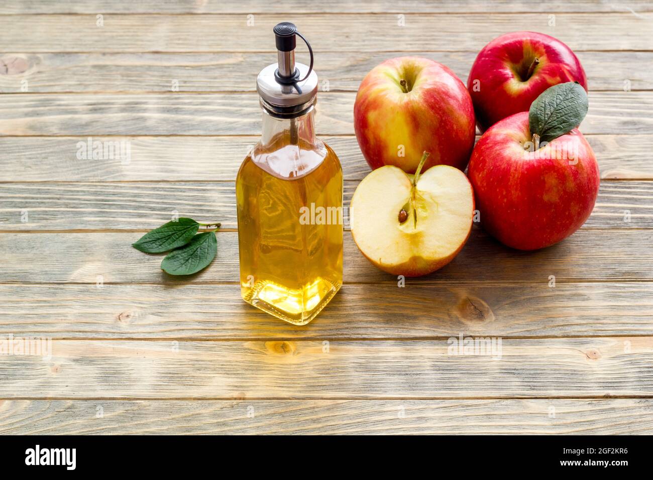Apple cider vinegar for cooking with red raw apples Stock Photo - Alamy