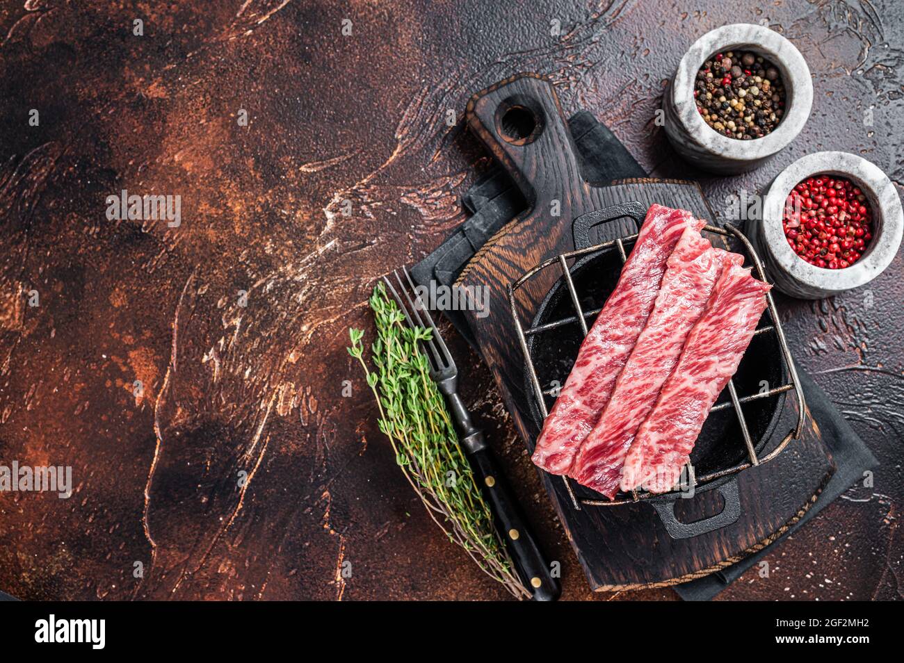 Premium raw sliced wagyu beef A5 steaks on a grill for yakiniku ...