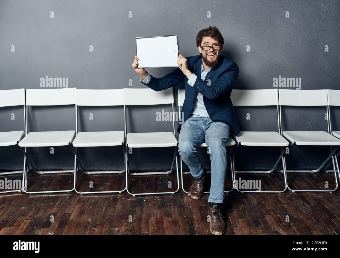 Man sitting on a chair resume job interview career Stock Photo - Alamy