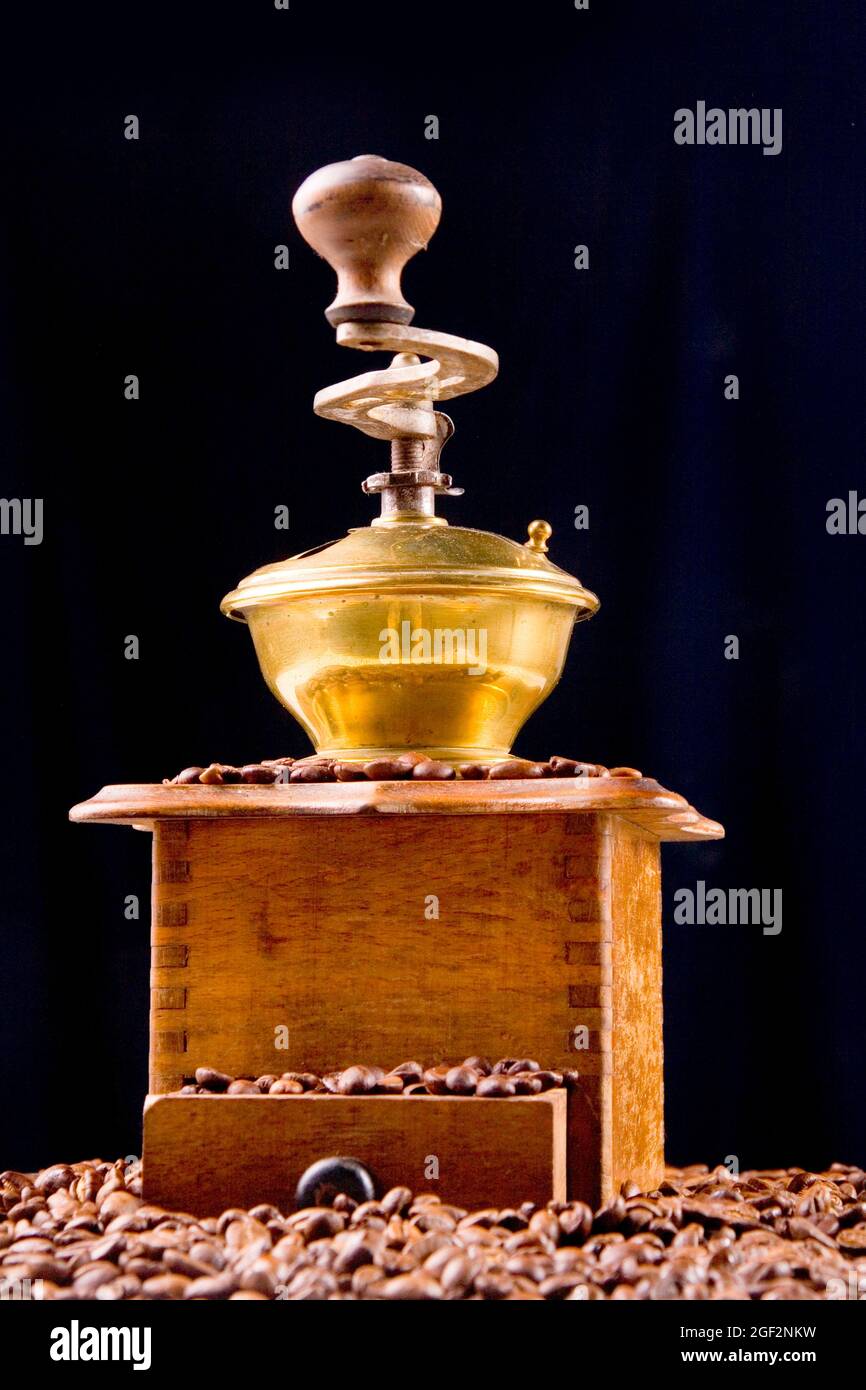 old-fashioned manual coffee mill with roasted coffee beans Stock Photo ...
