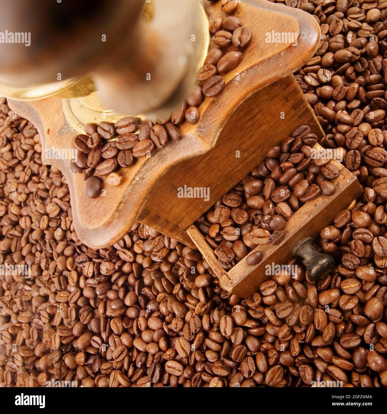 old-fashioned manual coffee mill with roasted coffee beans Stock Photo ...
