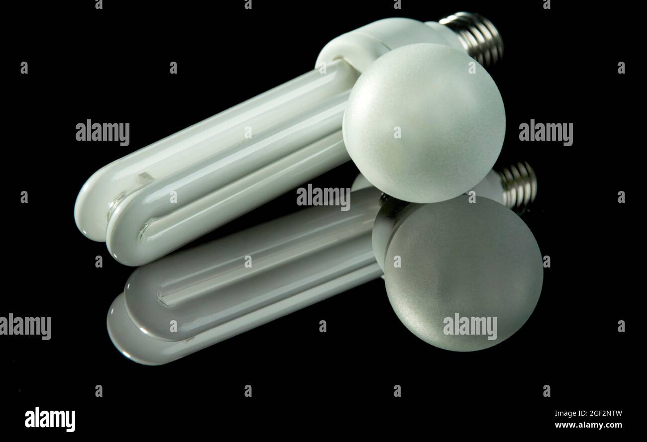 energy-saving lamps against black background Stock Photo - Alamy