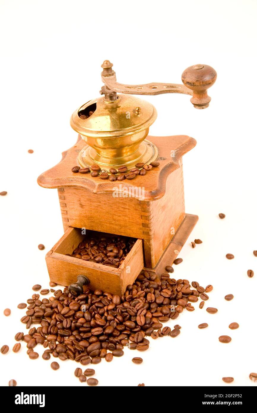 old-fashioned manual coffee mill with roasted coffee beans Stock Photo ...
