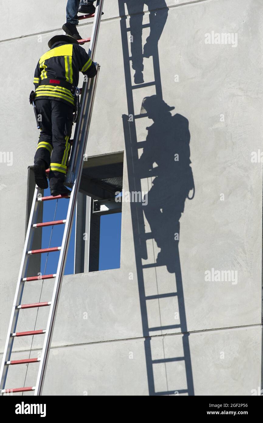rescue of a person from a house via a ladder by a firefighter Stock ...