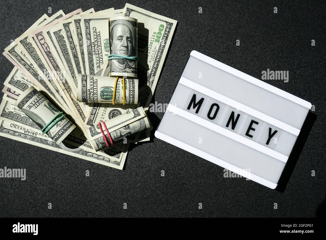 Lightbox board with the word MONEY in black letters around Us dollars ...