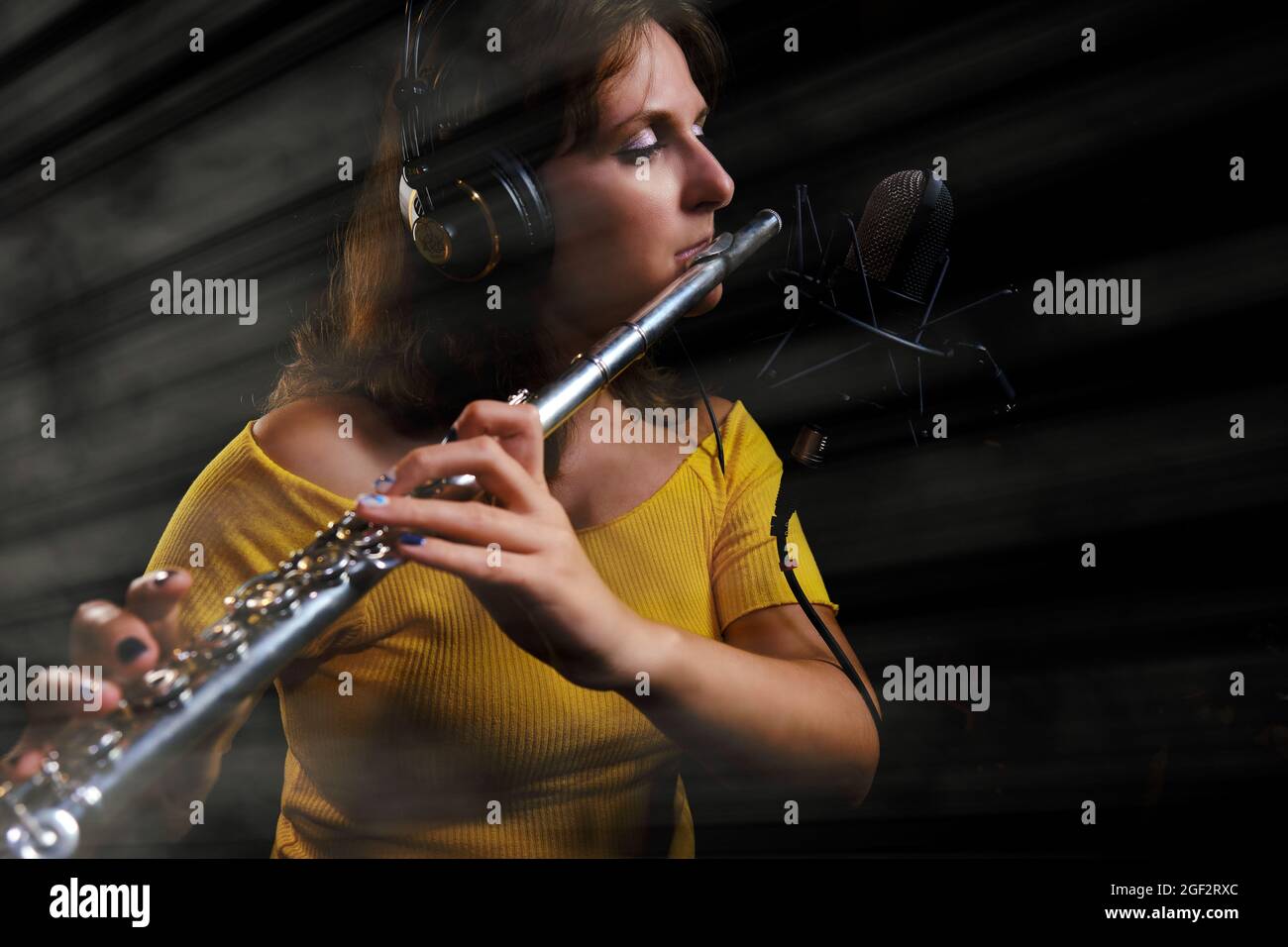 Professional recording of musical instruments at studio. Flautist in ...