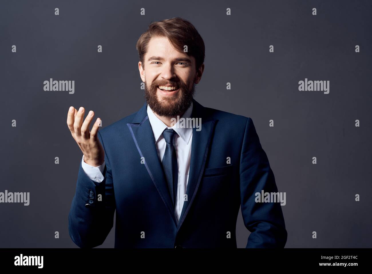 The man in a suit executive office dark background Stock Photo - Alamy