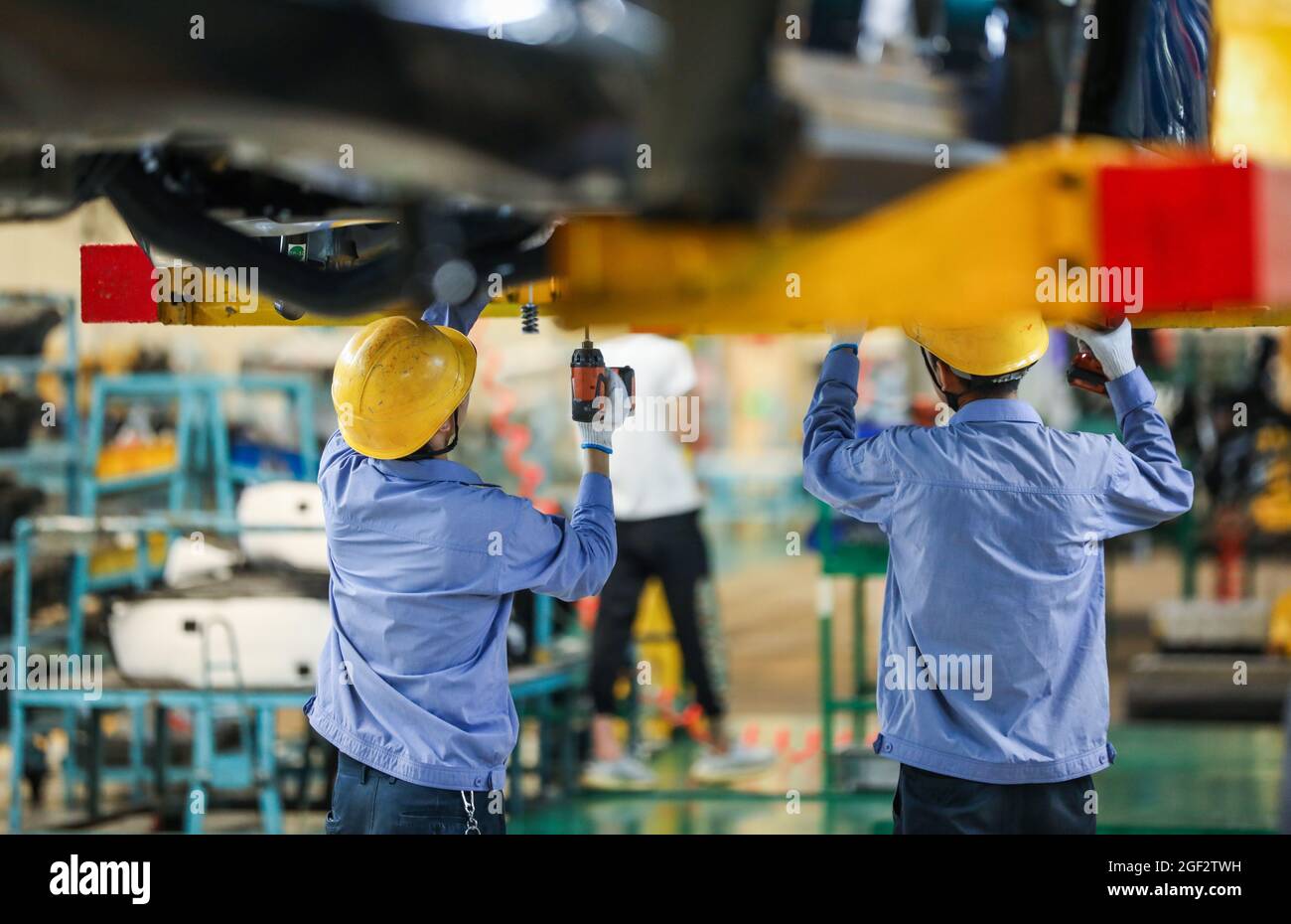 HAIKOU, CHINA - AUGUST 23, 2021 - Workers assemble electric vehicles on ...