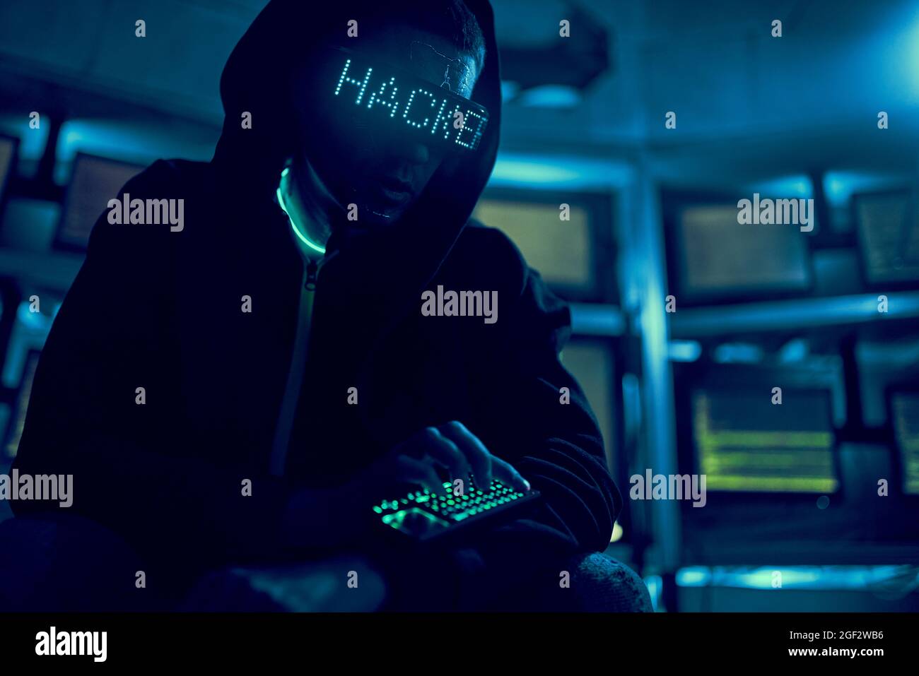 Cyber hacker breaks into databases to obtain information using a computer. Cybercrime and data ...