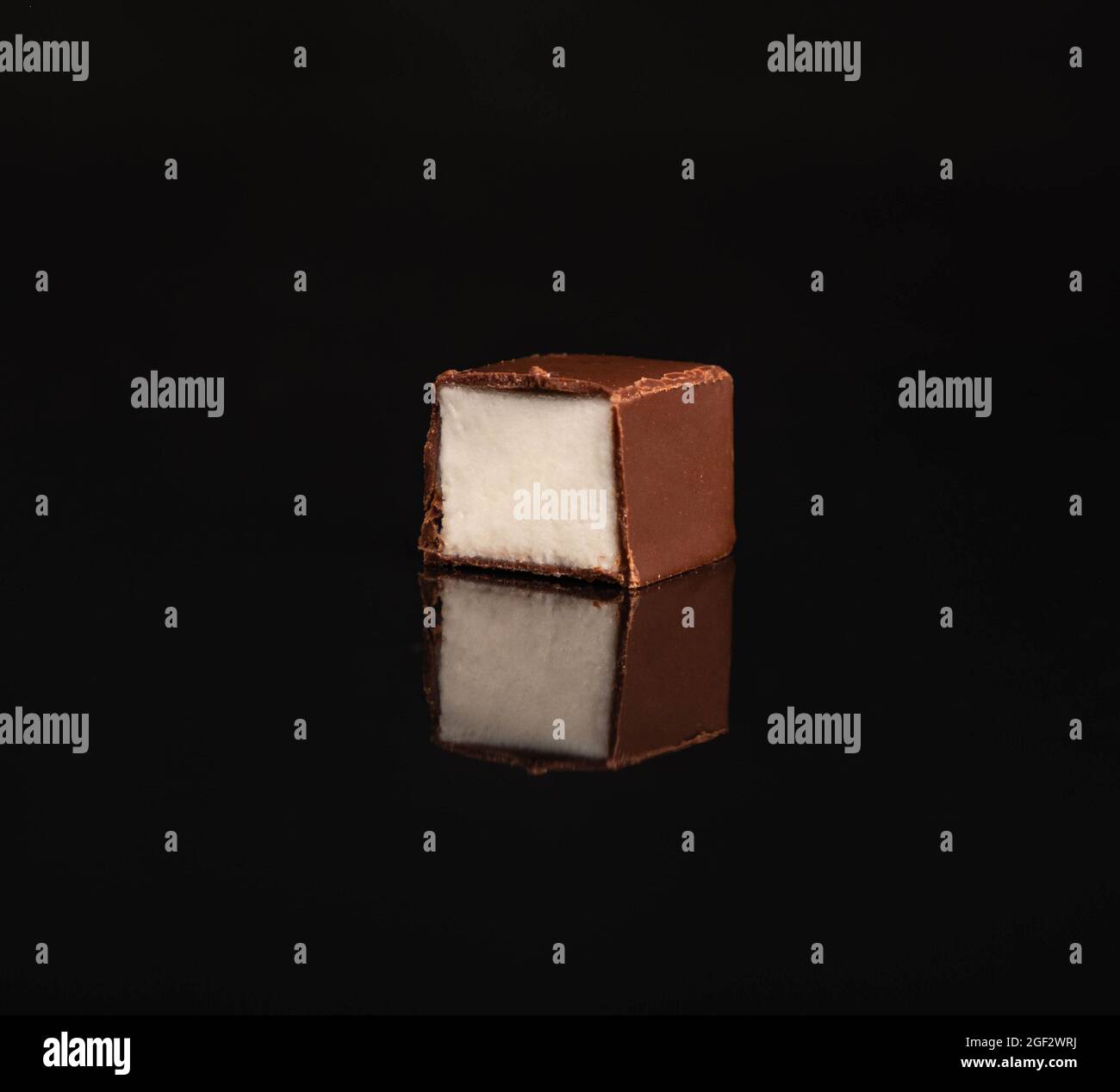 Bird's milk on a black candy cane background Stock Photo - Alamy