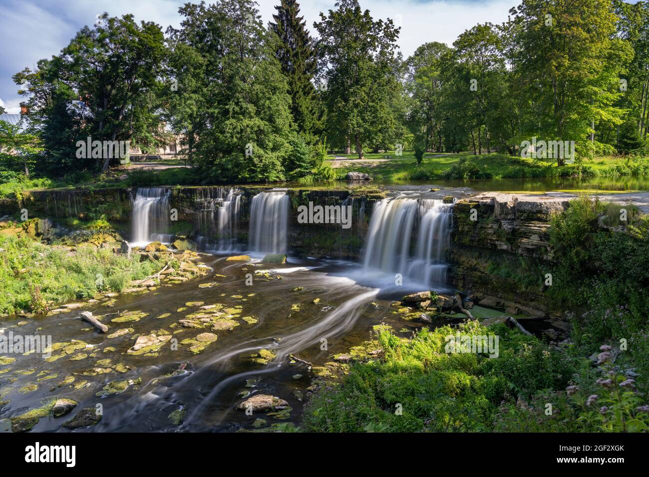 An idyllic river landscape in the forest with a waterfall Stock Photo ...