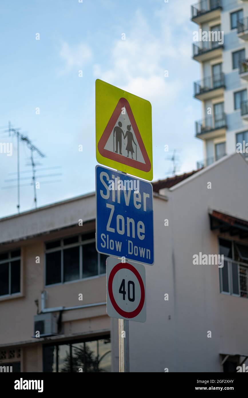 Silver zone slow down sign - traffic information sign Stock Photo - Alamy