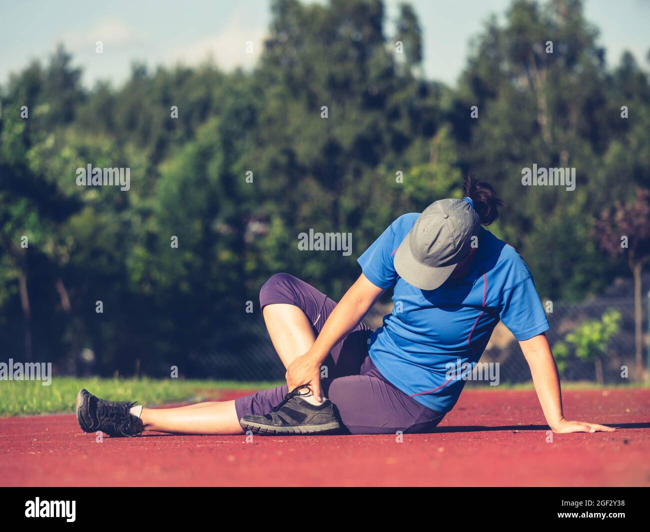 Female runner practise yoga and stretching body from back to legs cramp ...