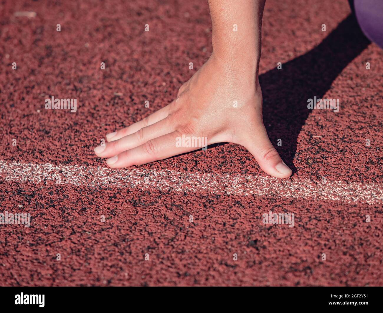 Female wrist with outstretched fingers at the starting line of a ...