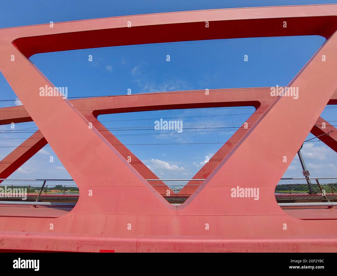 Red coulered steel train brigde named Hanzeboog over river IJssel in ...