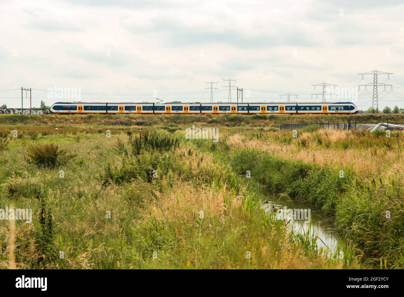 SLT commuter train on railroad track between Capelle and Nieuwerkerk ...