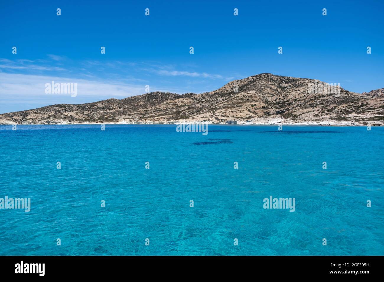 Polyaigos island with volcanic sandy beach calm Aegean sparkle sea blue ...