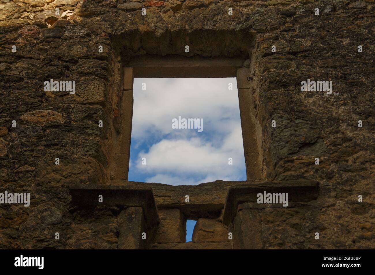 Low angle shot of a small window aperture in the medieval building's ...