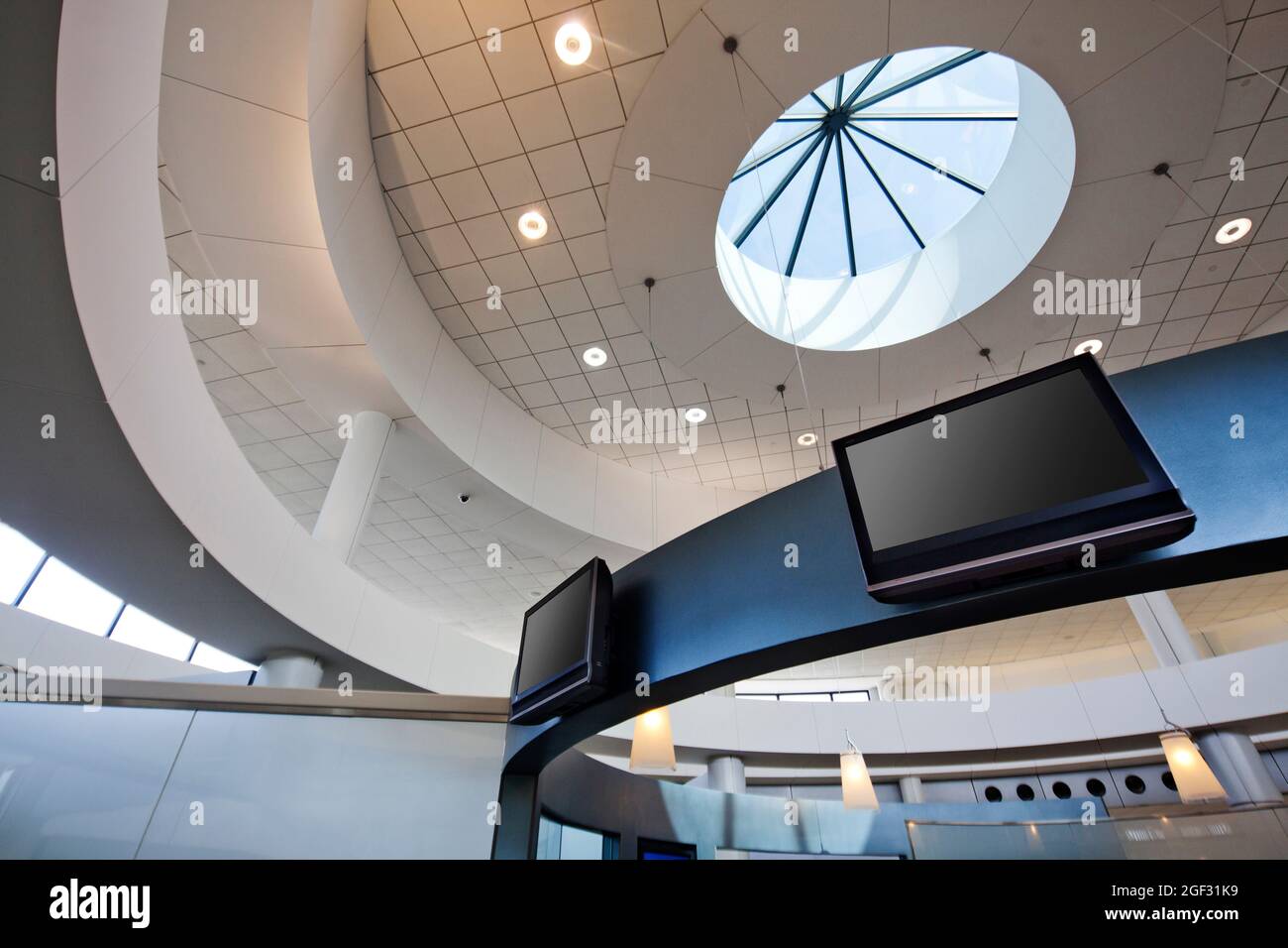 A view from below to a round dome ceiling with a central skylight ...