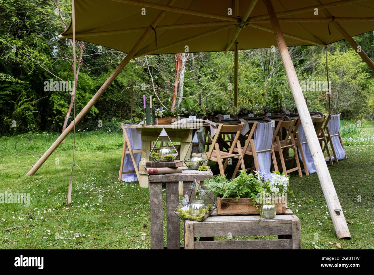 Dining table and chairs under a canopy for a woodland naming ceremony ...
