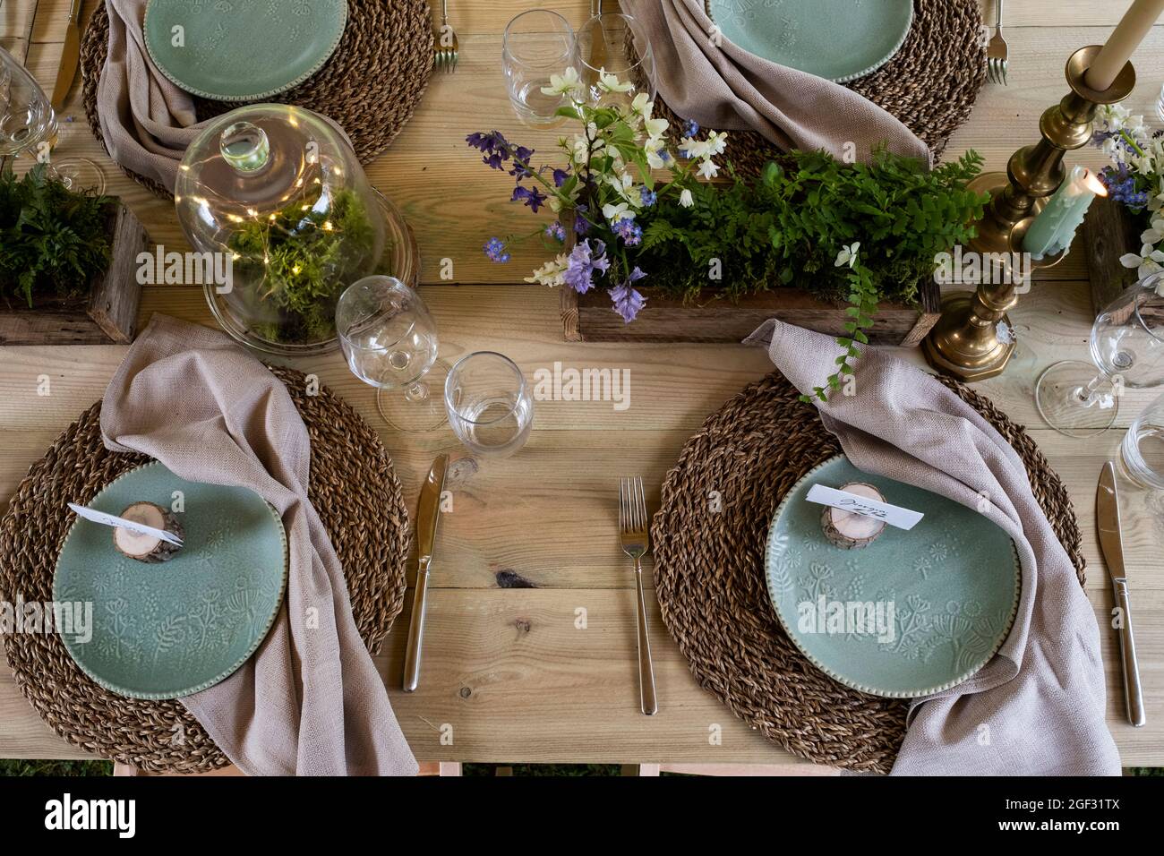 High angle close up of rustic place settings for a woodland naming ...