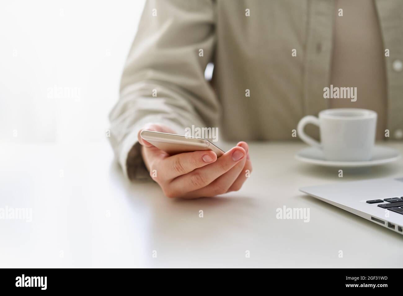 Millennial female using smartphone during coffee break at work. Concept ...