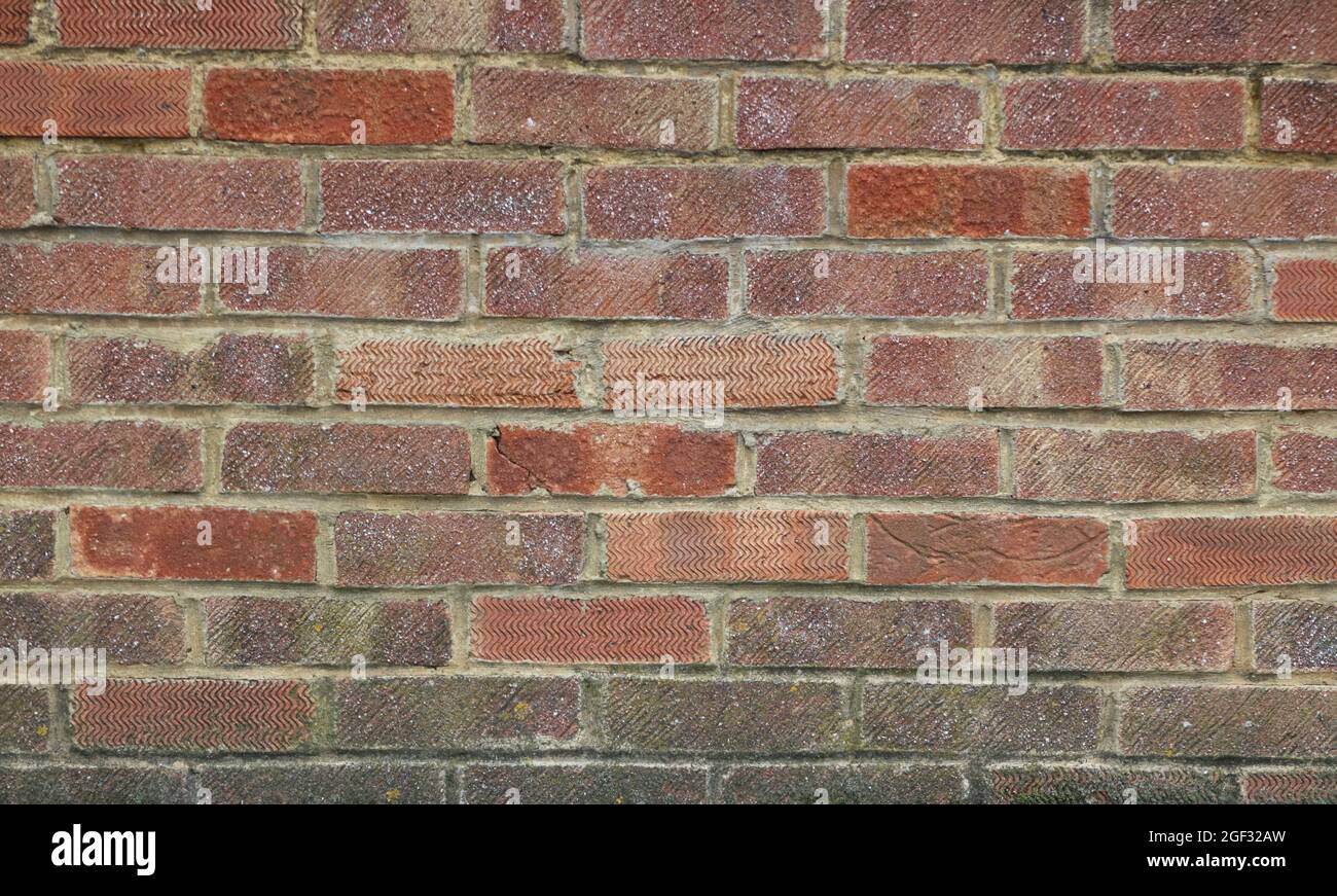 Old weathered brick wall in assorted coloured blocks with copy space ...