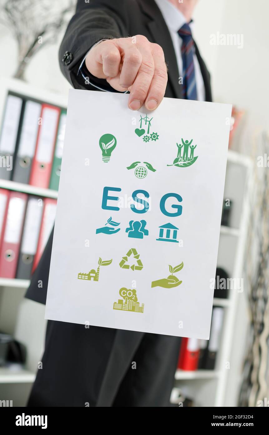 Paper showing esg concept held by a businessman Stock Photo - Alamy