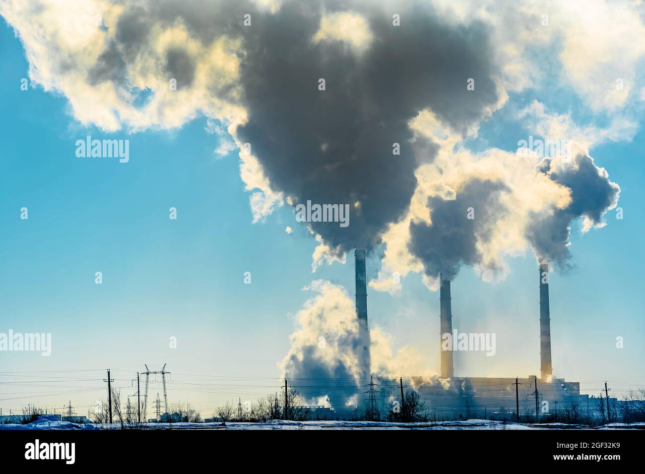 Sunset over the industrial city.Factory chimneys smoke.Environmental ...