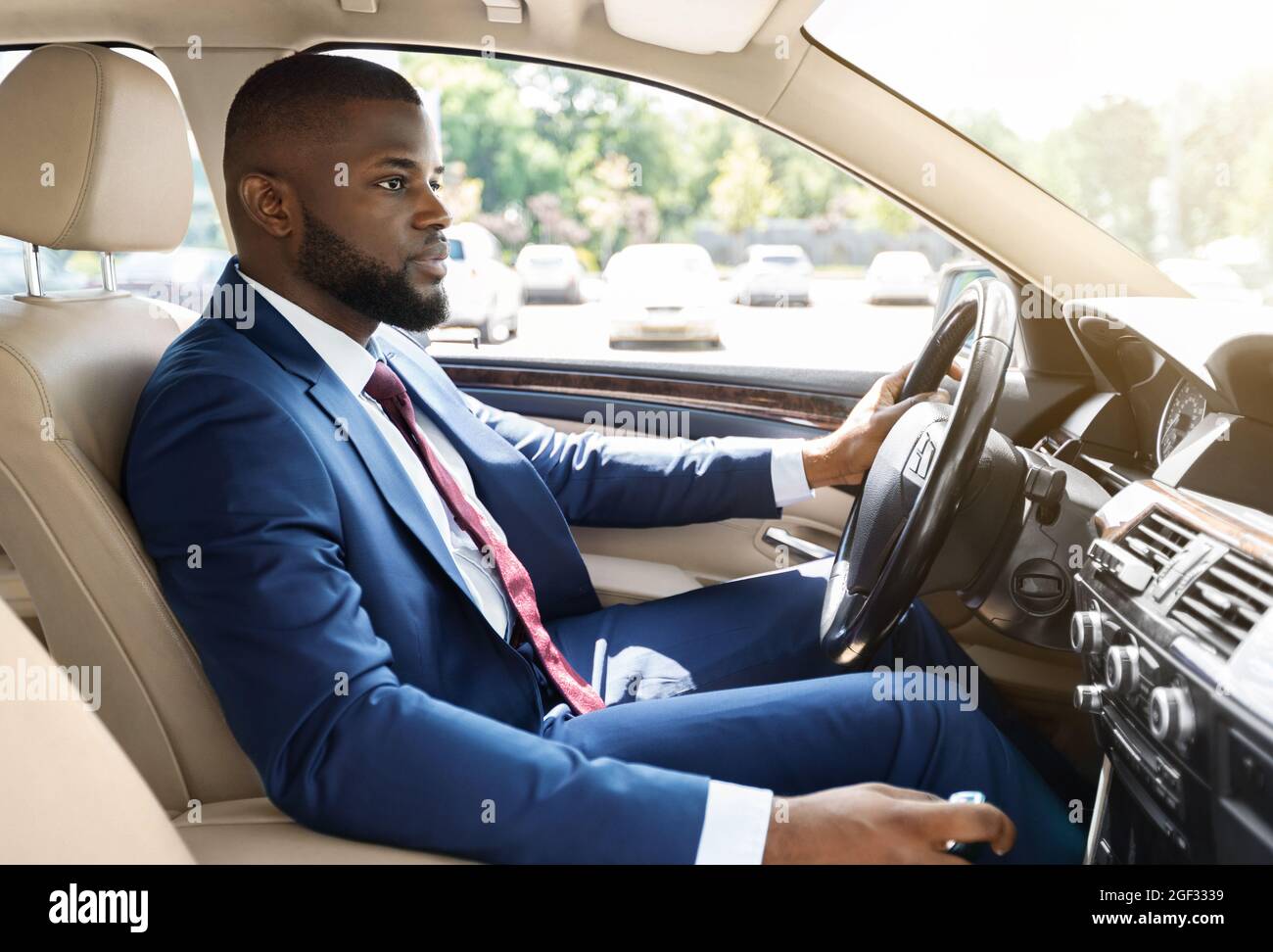 Confident afro american businessman driving car to office Stock Photo ...