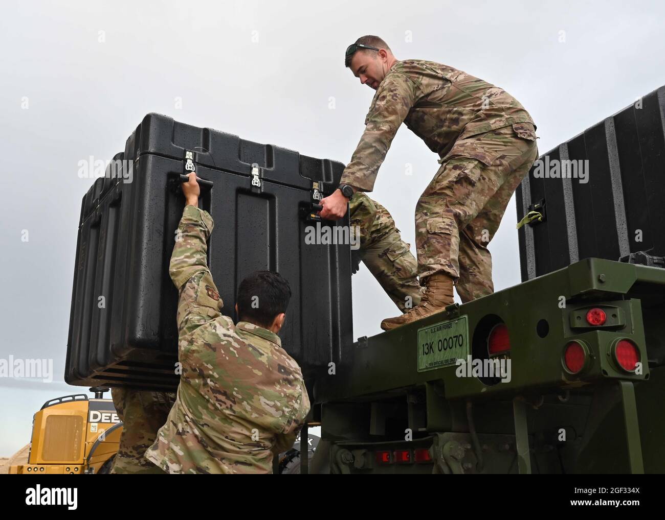 Airmen assigned to the 1st Combat Communications Squadron load cargo ...