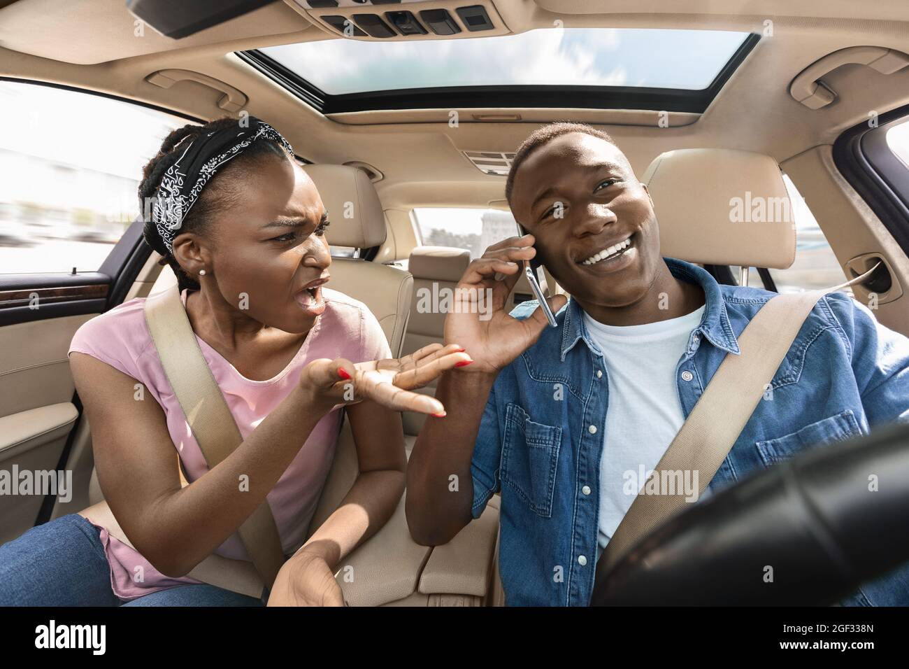 Black woman yelling at boyfriend having phone call while driving Stock ...
