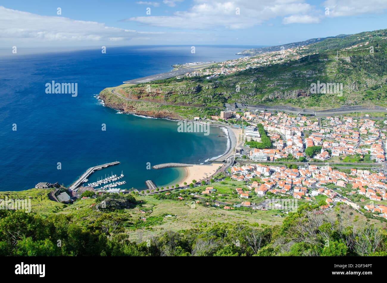 Aerial view of the beach with green hills and buildings. Machico ...