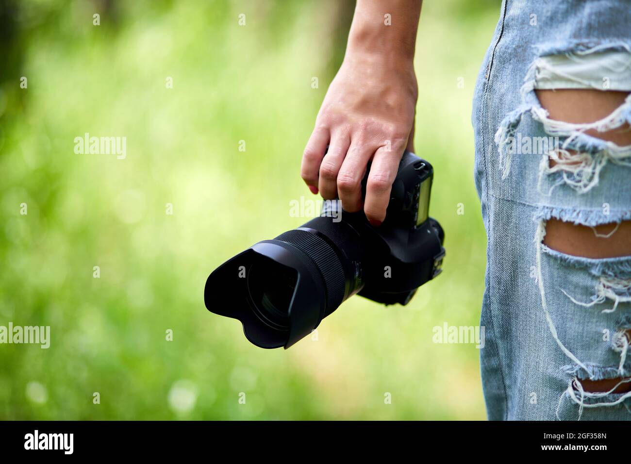 Woman photographer with a photo camera in hand outdoor, World ...
