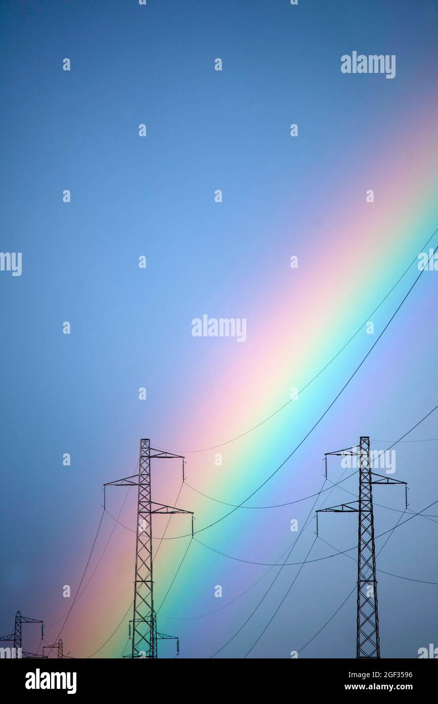 Effects arc of a rainbow near a high-voltage power line Stock Photo - Alamy