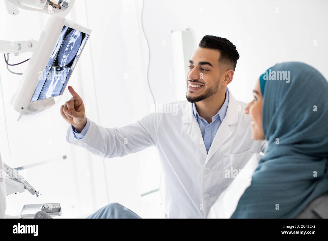Middle-Eastern Stomatologist Showing Teeth Xray Picture On Digital ...