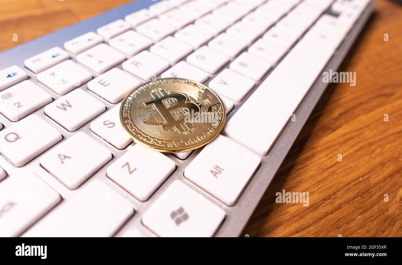 Bitcoin cryptocurrency coin on the background of the computer keyboard ...