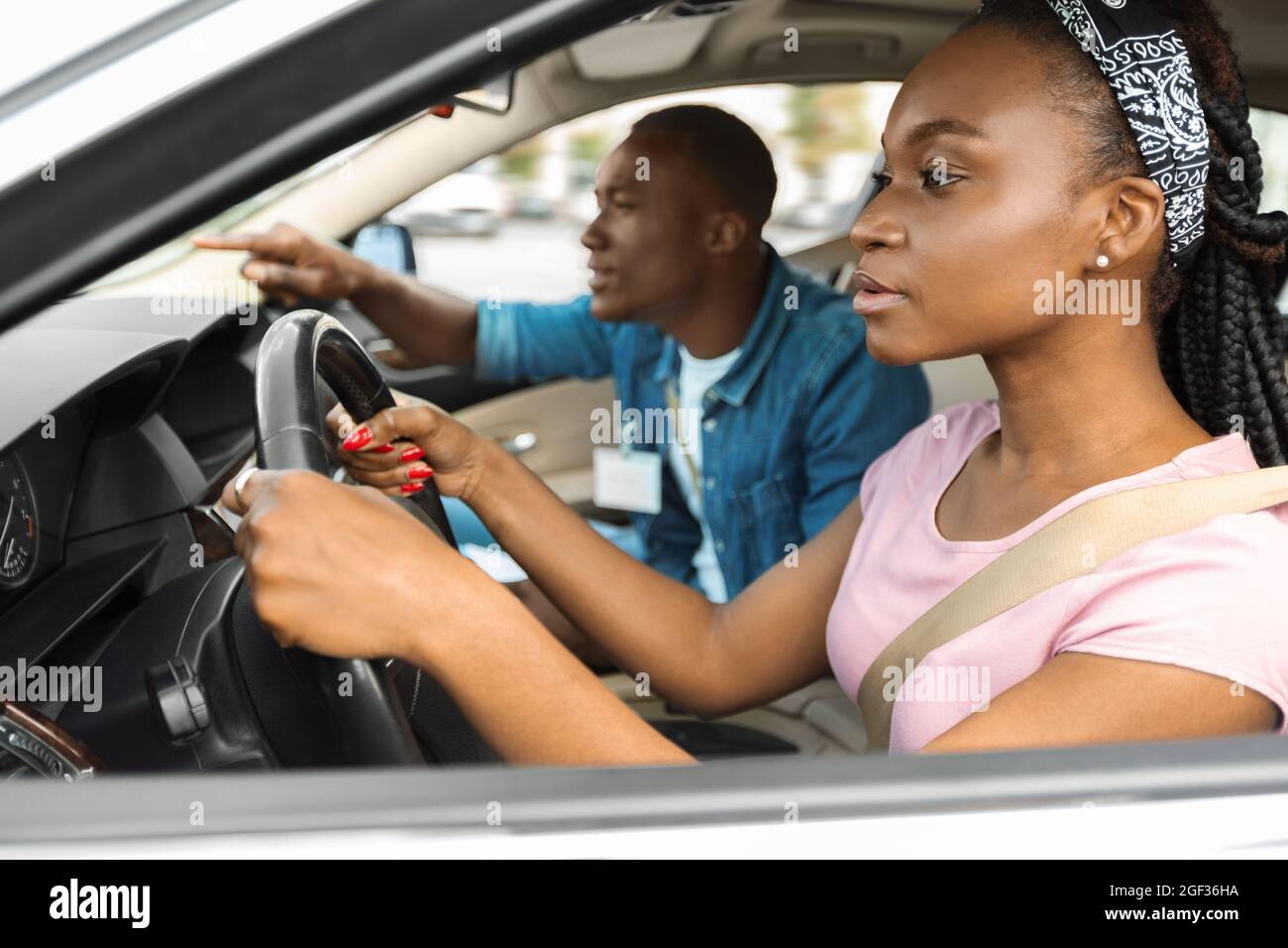 Concentrated black woman practicing parking at driving school Stock ...