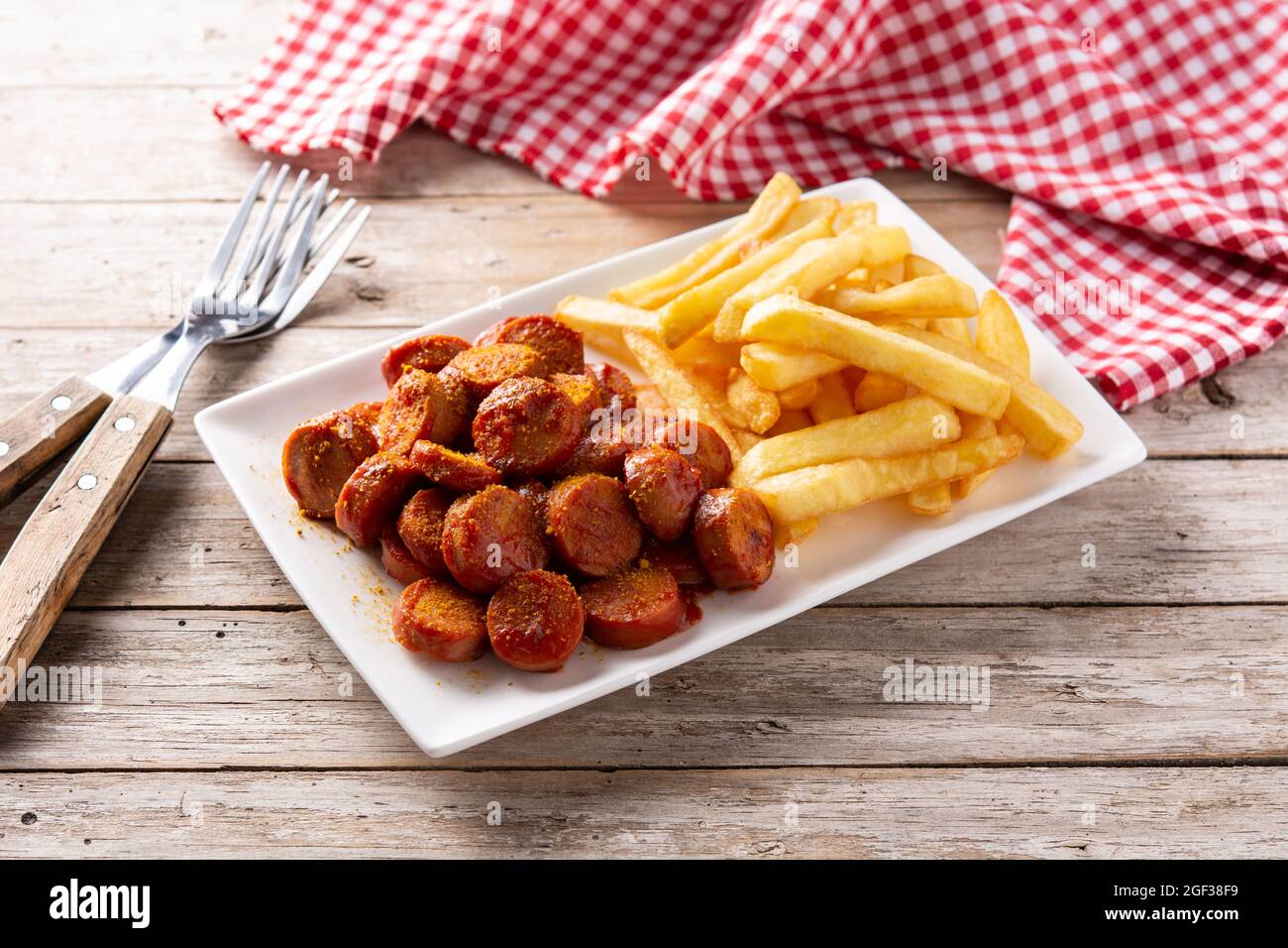 Traditional German currywurst on wooden table Stock Photo - Alamy