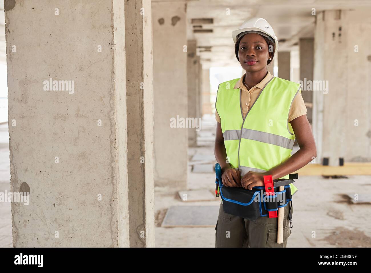 Waist up portrait of young African-American woman working at ...