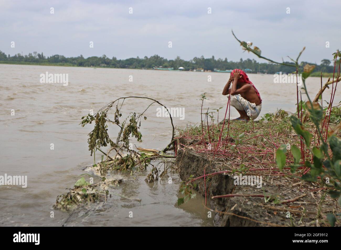 shows the eroded bank of a river in munshiganj district, Some 53 km ...